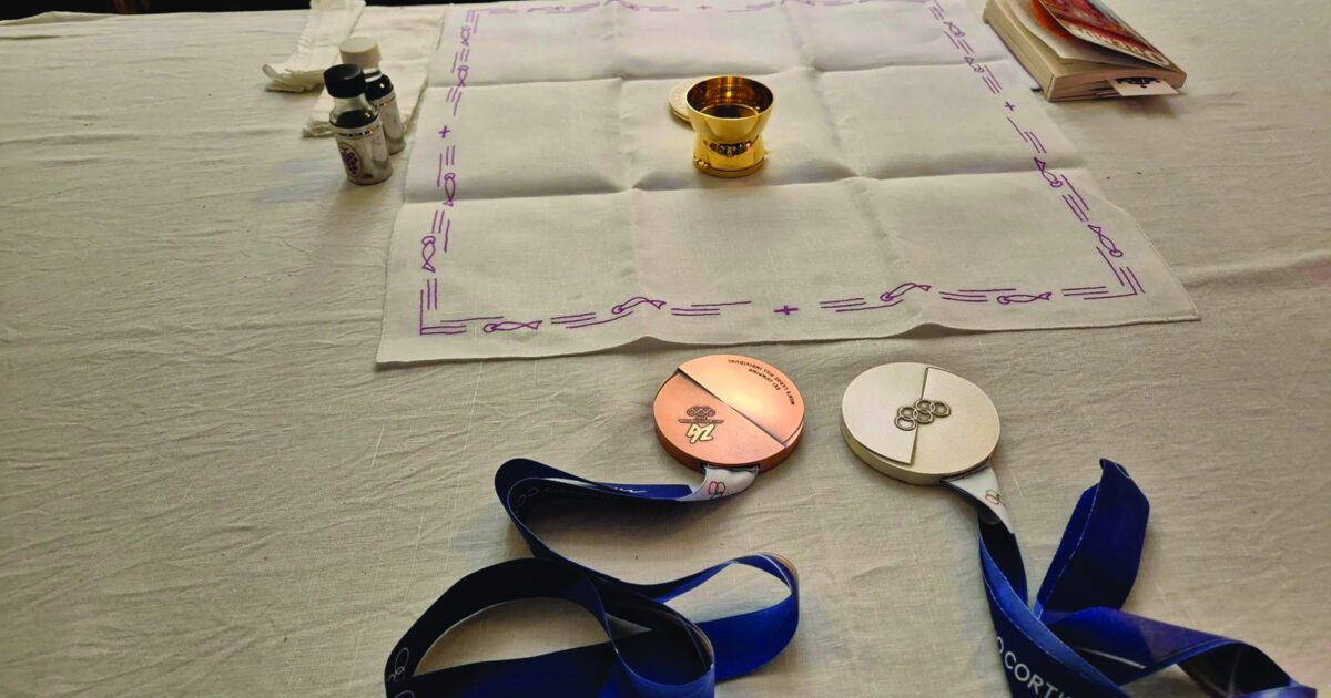 Olympic ski jumping silver, bronze medals lay on altar as young athlete ...